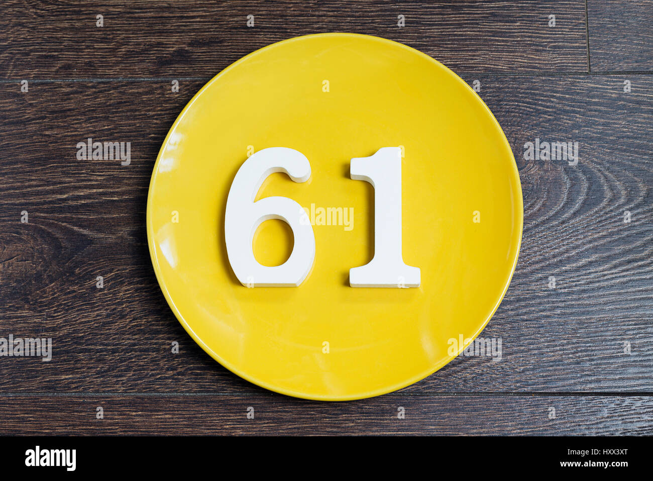 The number sixty-one on the yellow plate and brown background Stock ...