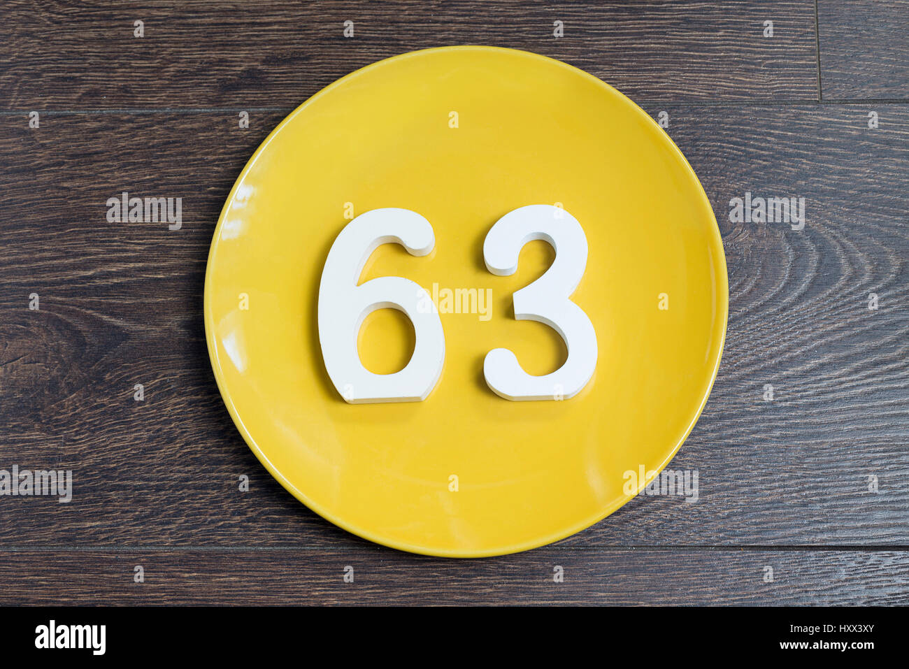 Figure sixty-three at the plate yellow and brown background Stock Photo ...
