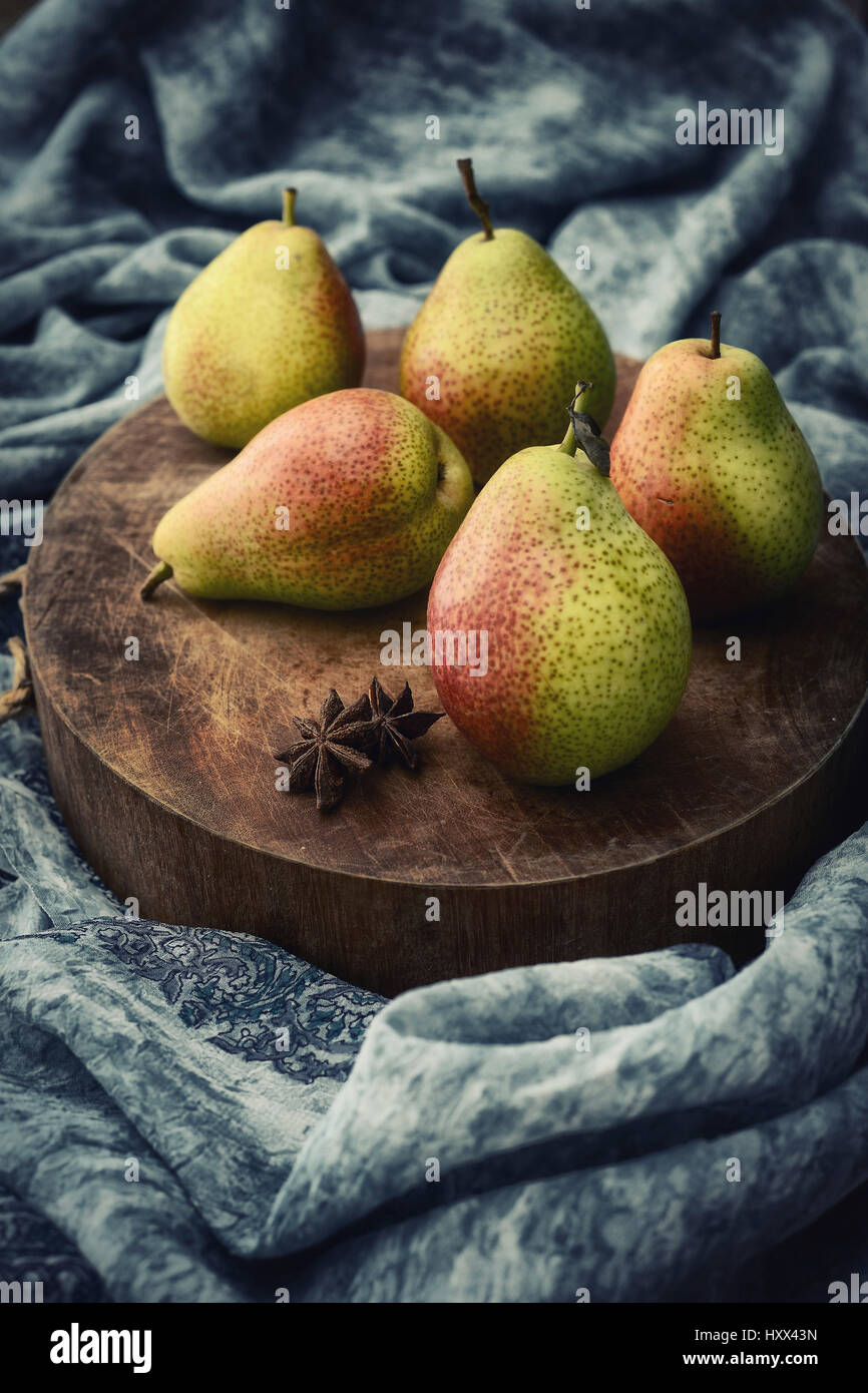 Five pears on a chopping board with rustic setup and styling Stock ...