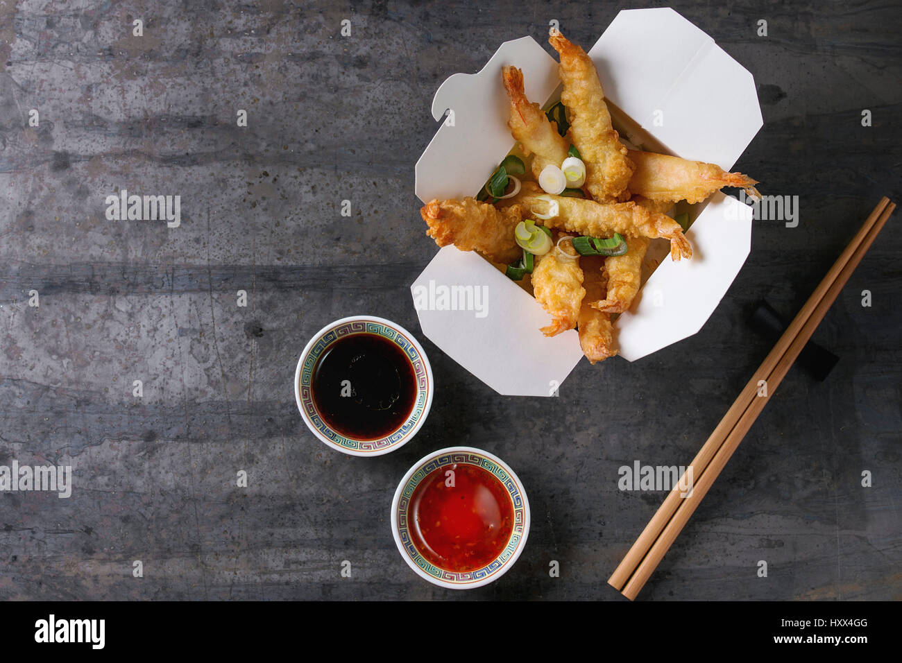 Fried tempura shrimps with rice and spring onion in paper to-go box ...