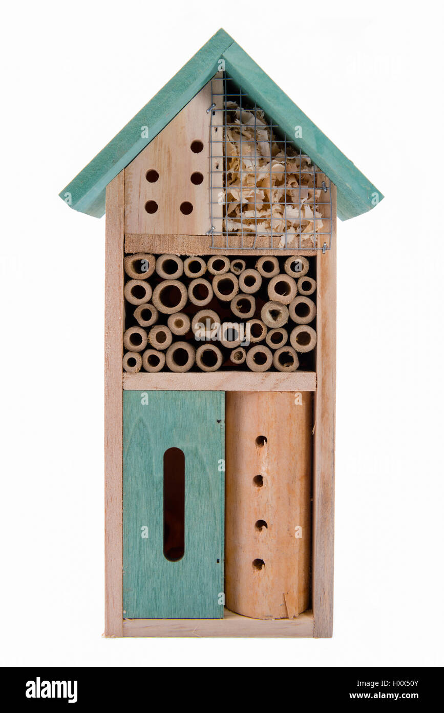 A wooden insect hotel with a green roof on white background Stock Photo ...