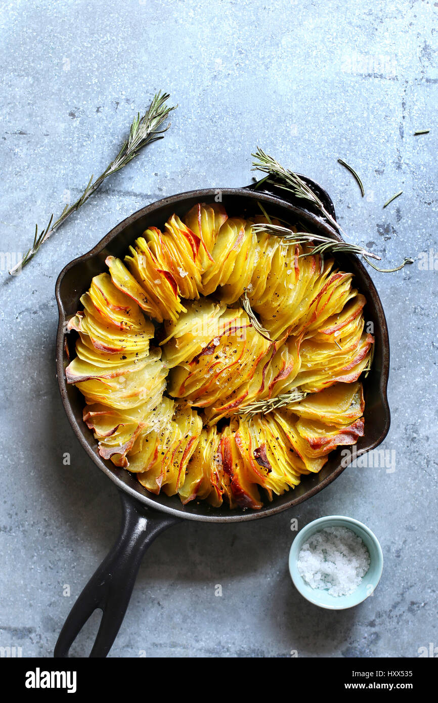 Crispy leaf potato roast on a frying pan,seasoned with salt and black ...