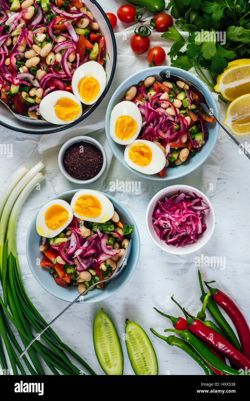 Turkish tangy bean salad known as piyaz served in bowls with halved ...