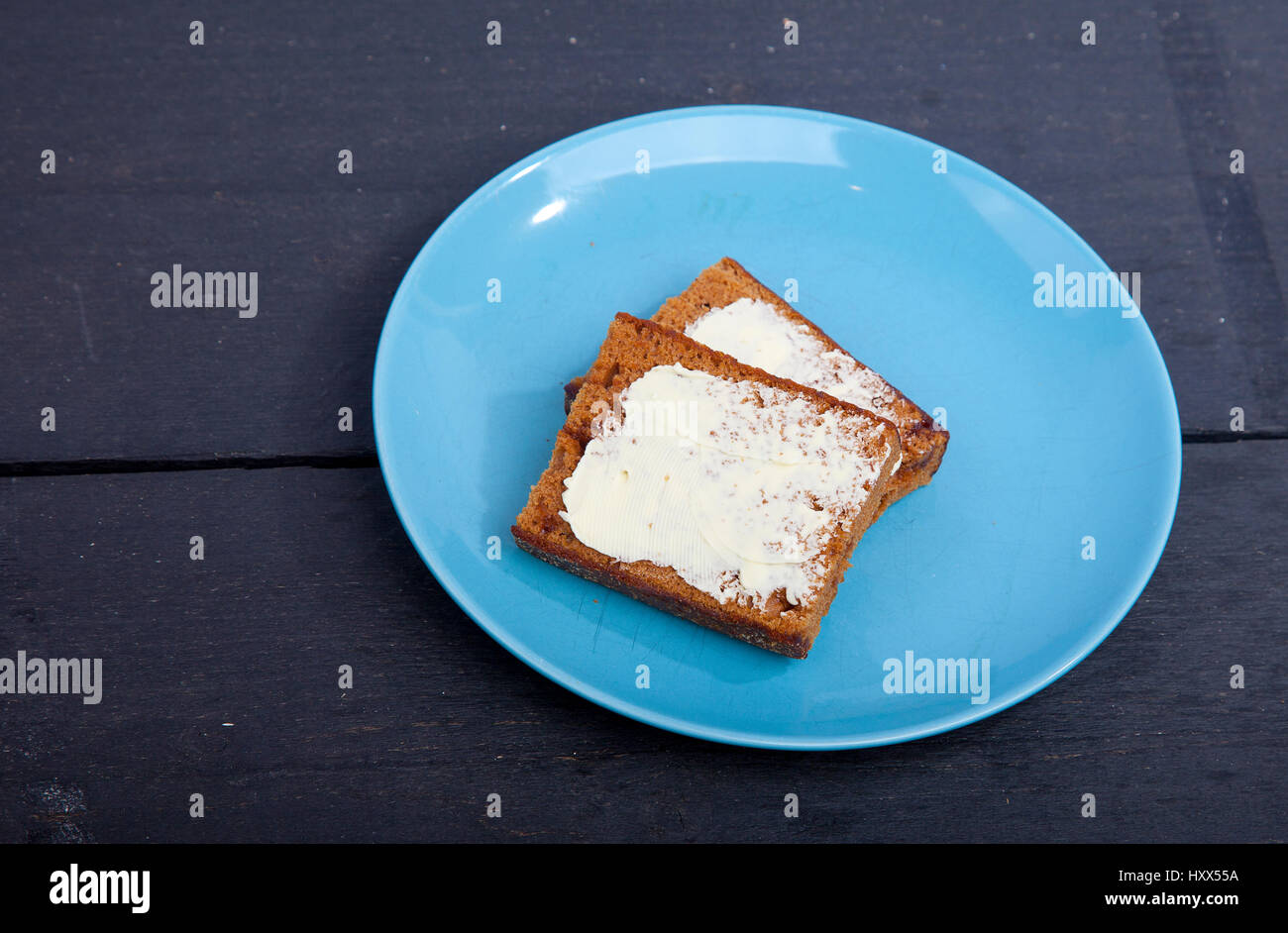 Traditional Dutch cake Ontbijtkoek with traditional butter on wooden ...