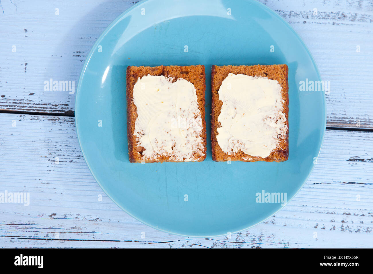Traditional Dutch cake Ontbijtkoek with traditional butter on wooden ...