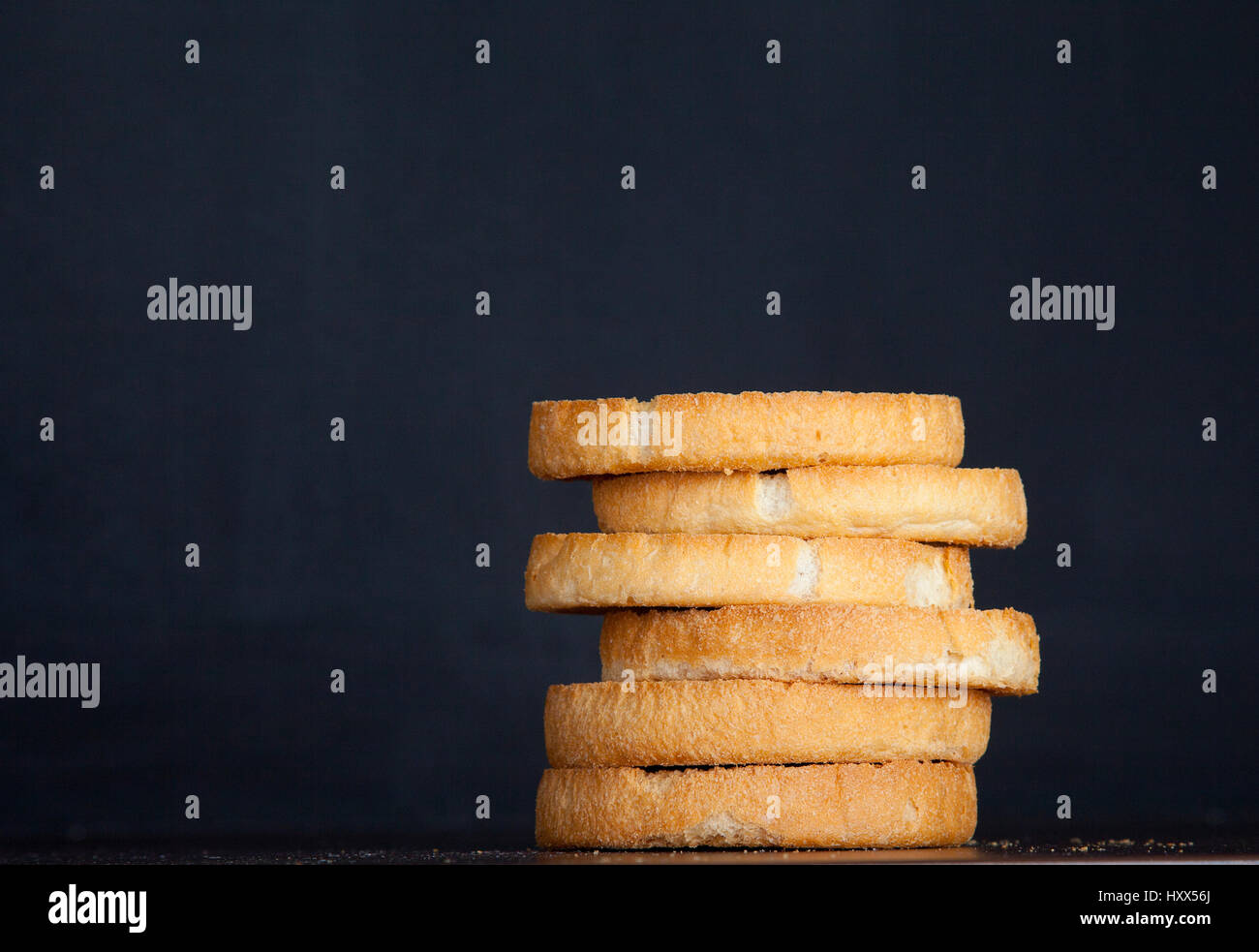 Pile of Dutch beschuit on black dark background Stock Photo - Alamy
