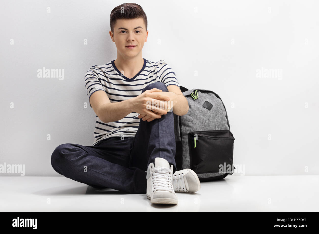 Boy leaning against wall hi-res stock photography and images - Alamy