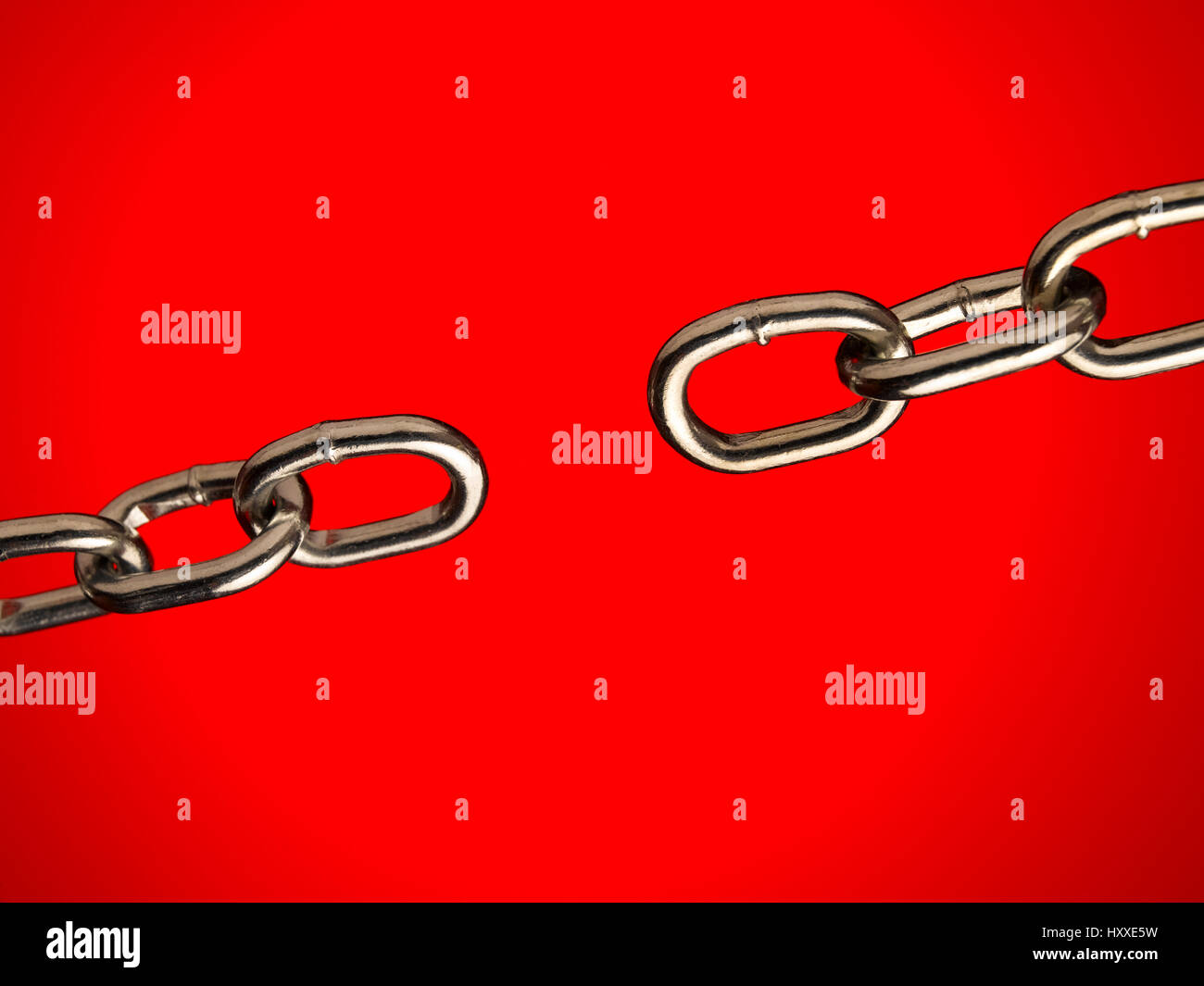 Broke Chain on red Stock Photo - Alamy