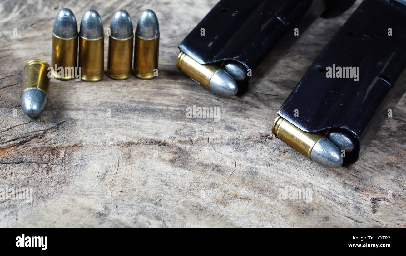 Bullets and a firearm on the wood. Bullets are a projectile expelled ...