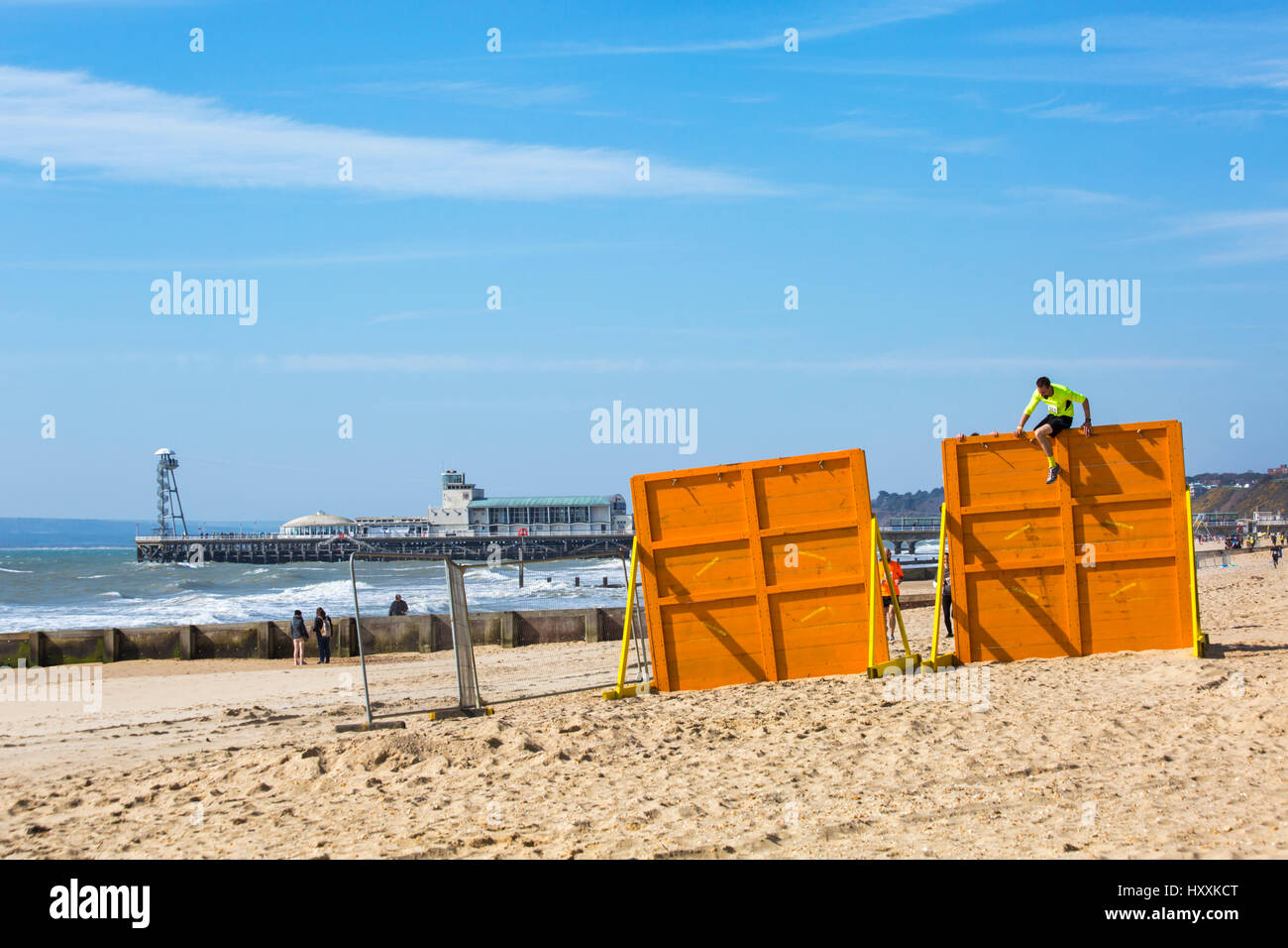Climbing over obstacle course as part of the Sandstorm Challenge on ...