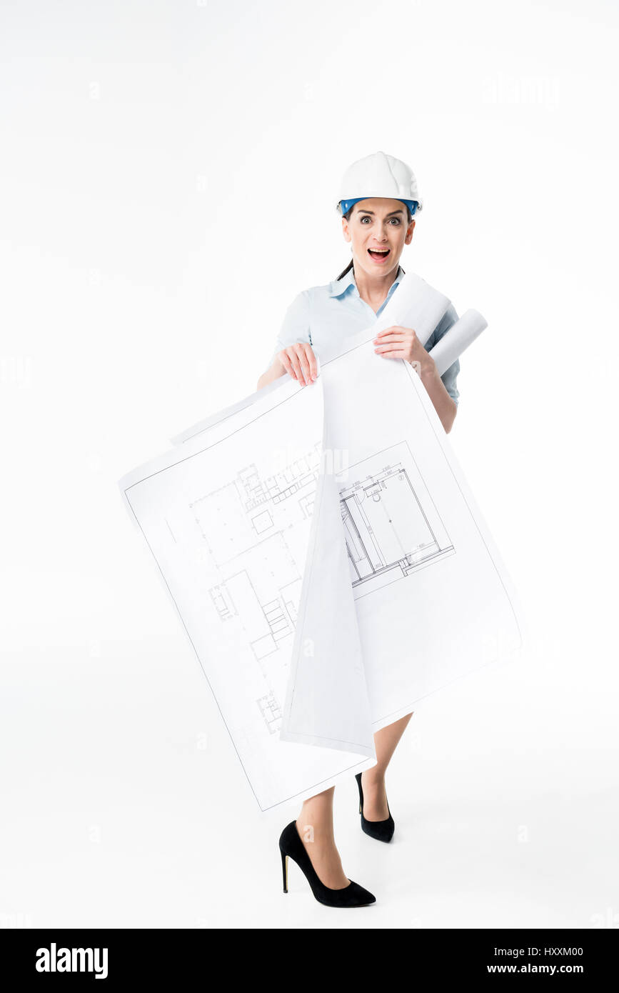Confused female architect in hard hat holding blueprints on white Stock ...