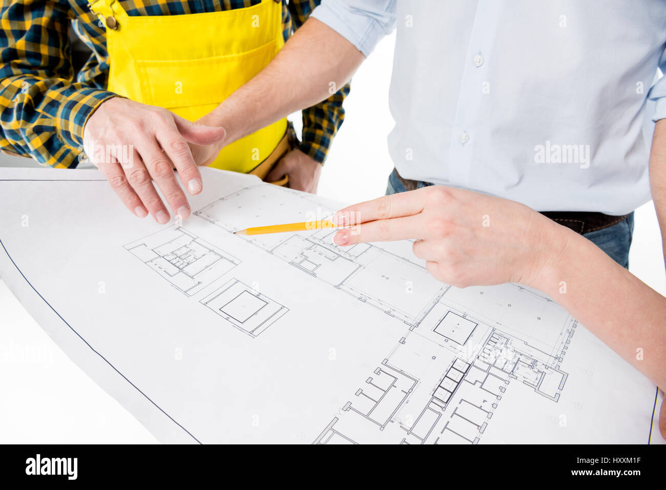 Partial view of architects examining blueprint together Stock Photo - Alamy