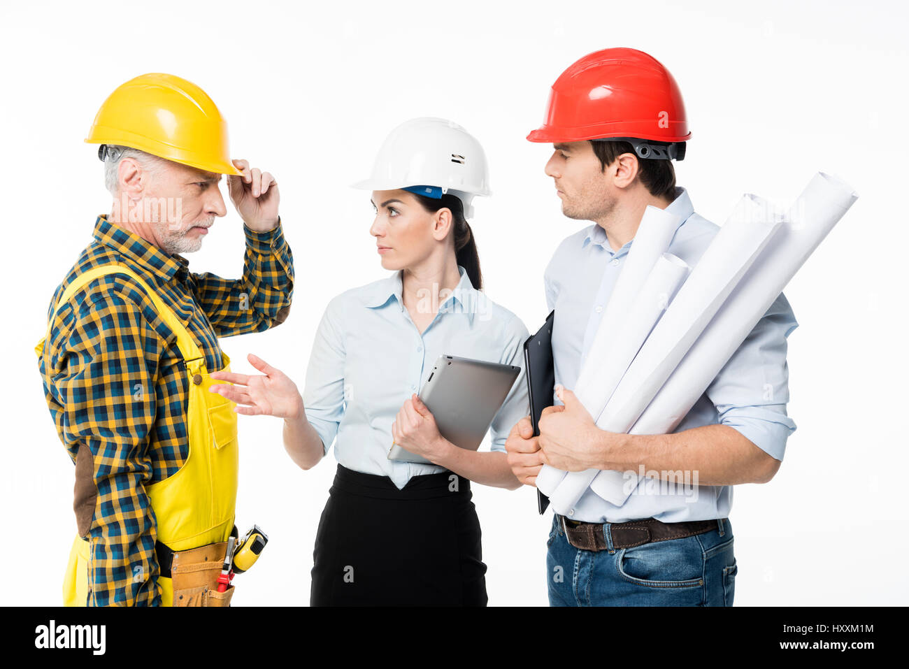 Two architects and mature workman discussing work Stock Photo - Alamy
