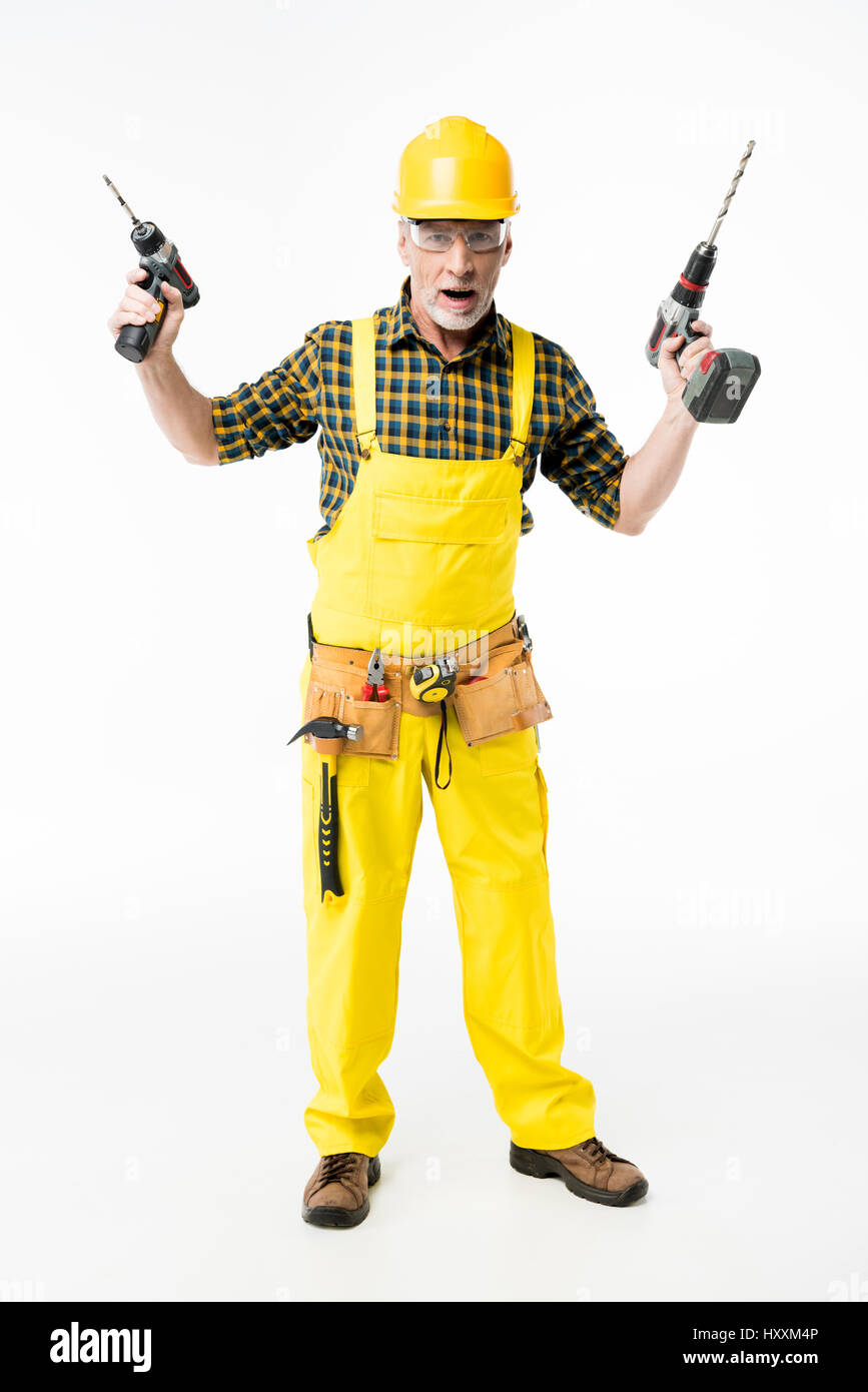 Full length portrait of mature workman holding electric drills Stock ...