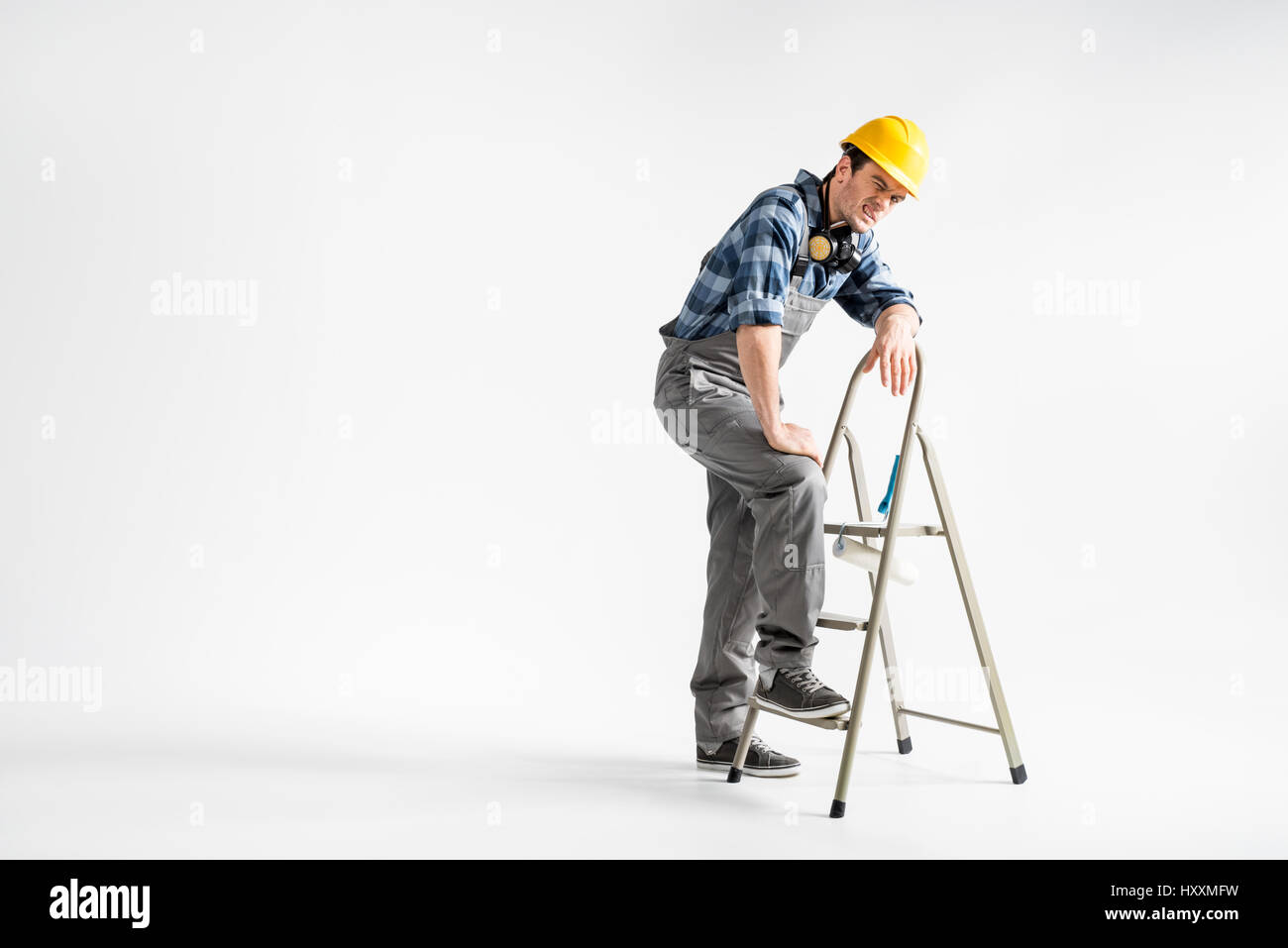 Full length portrait of professional male construction worker leaning ...