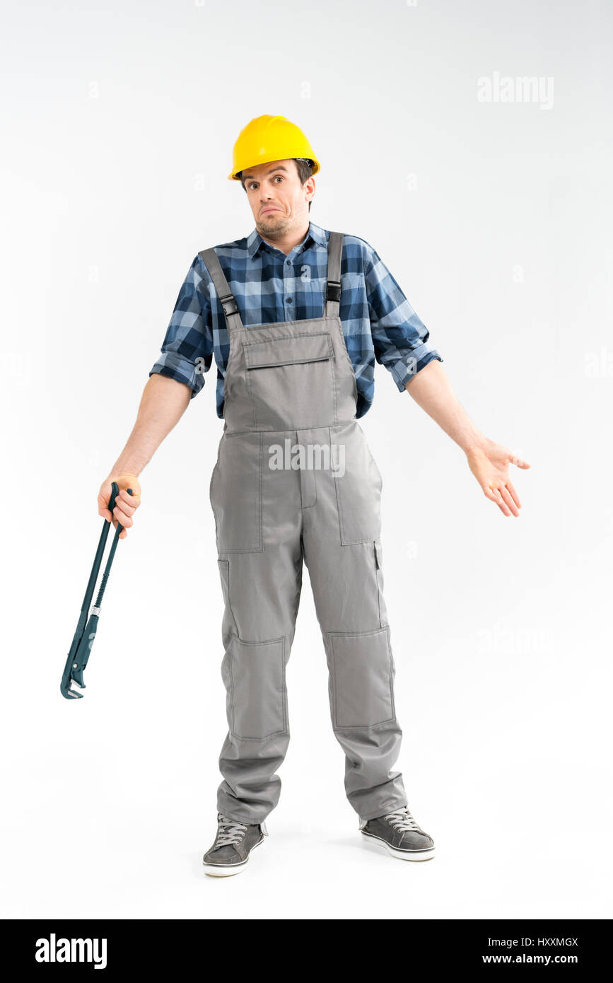Full length portrait of confused professional male construction worker ...