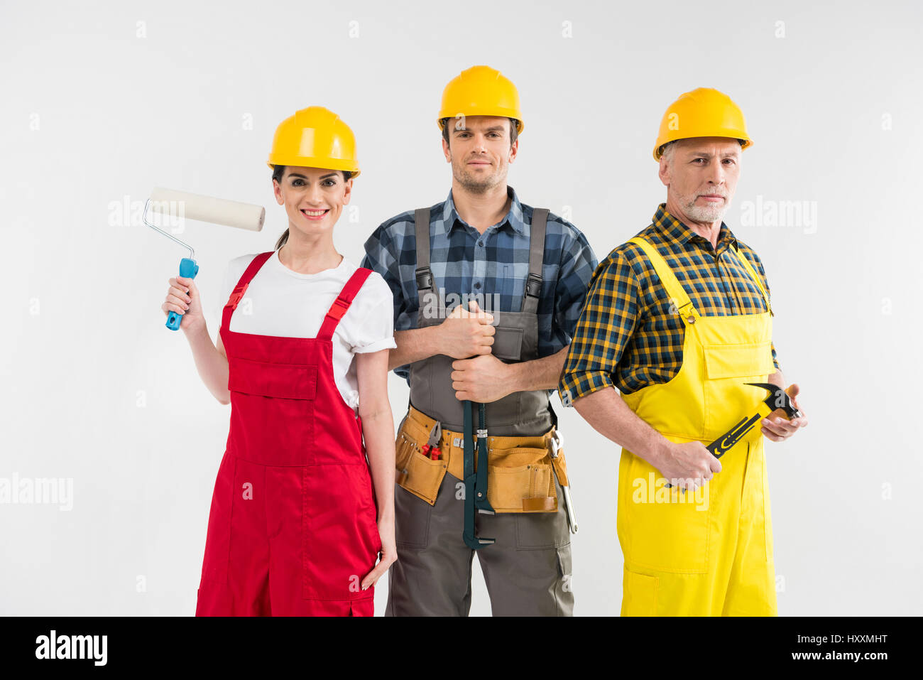 Group of professional male and female construction workers smiling at ...