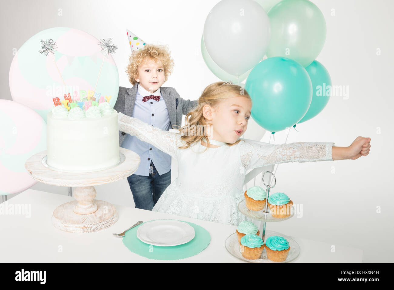 Happy little boy and girl celebrating Birthday with festive sweets ...