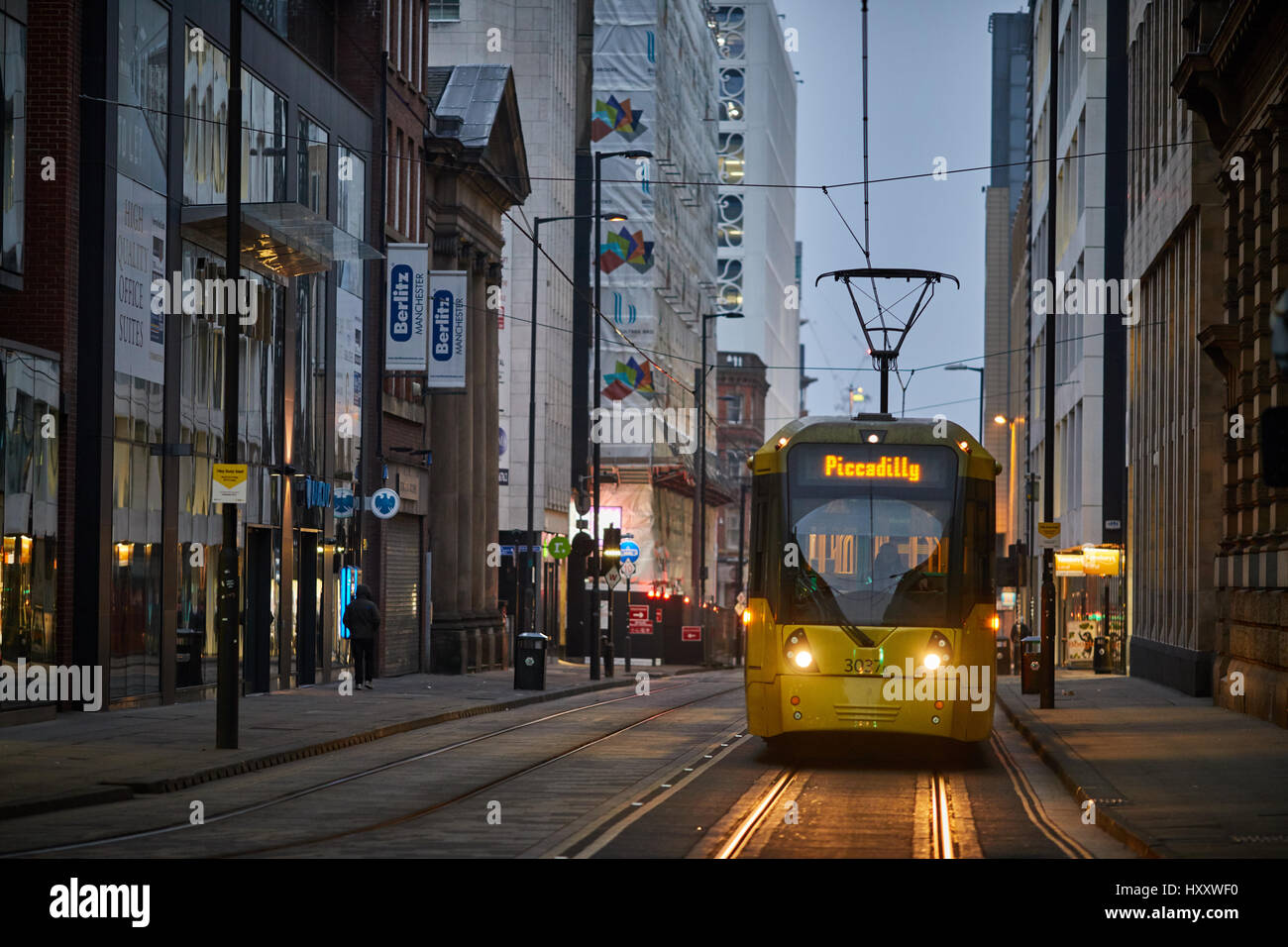 A yellow Metrolink tram on lower Mosley Street Manchester city centre ...