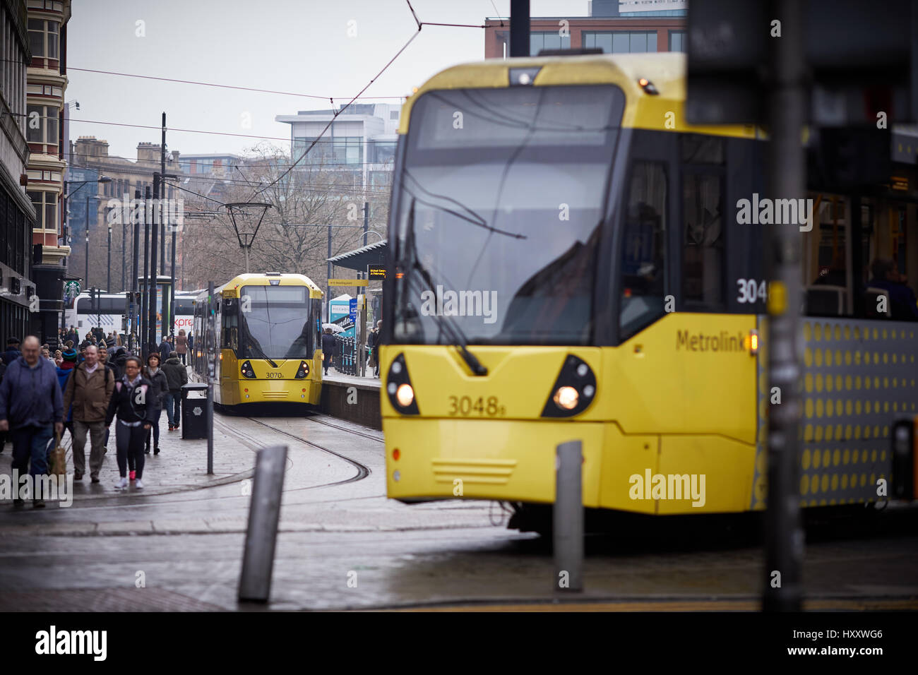 Two yellow Metrolink trams on Market Street Manchester city centre ...