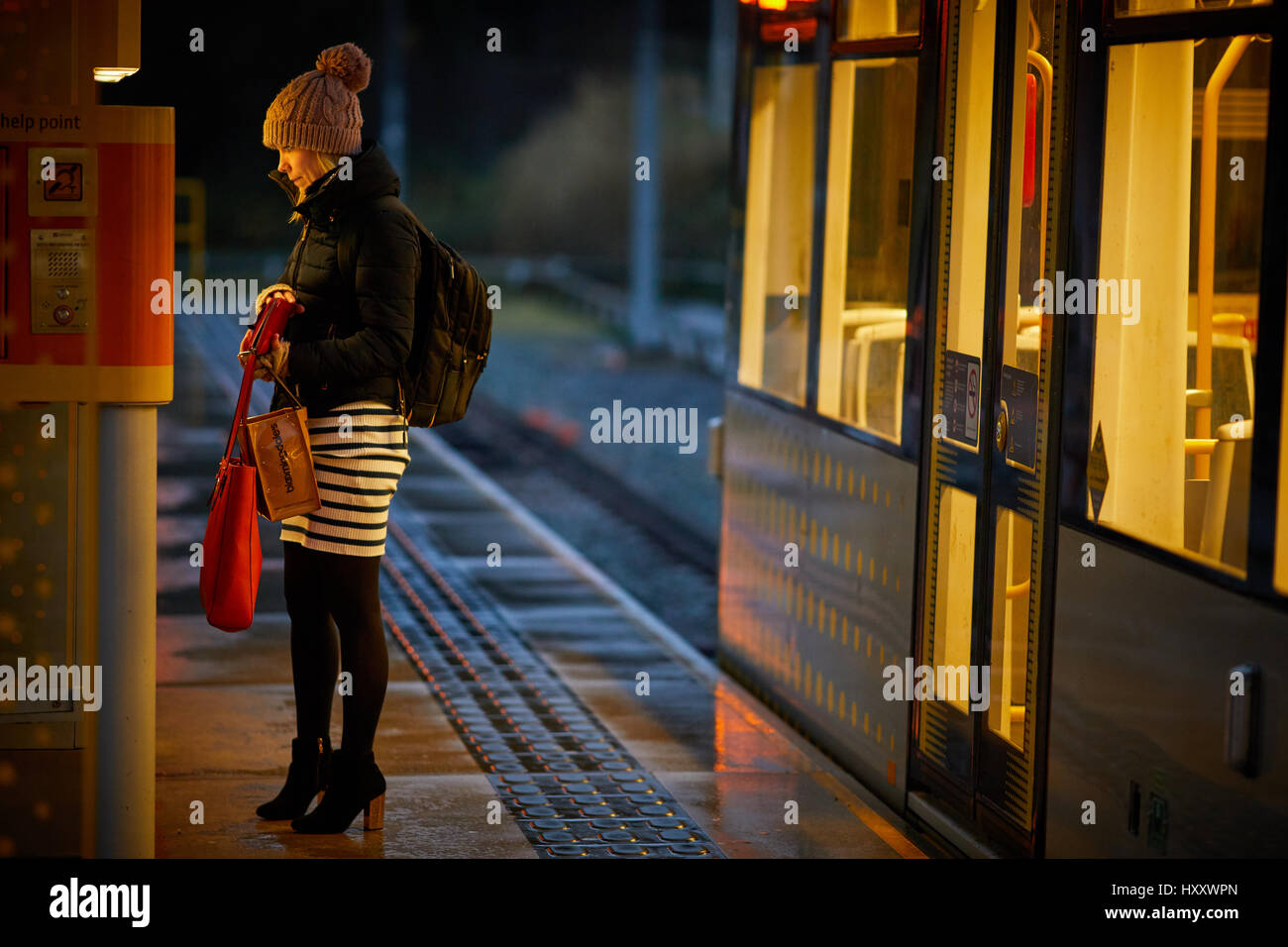 Daybreak a morning commuter Metrolink tram passenger buys her ticket at ...