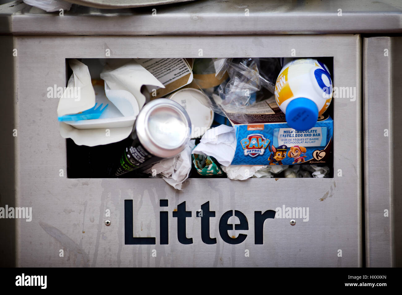 Litter bin overflowing onto the pavement and street at Stockport town ...