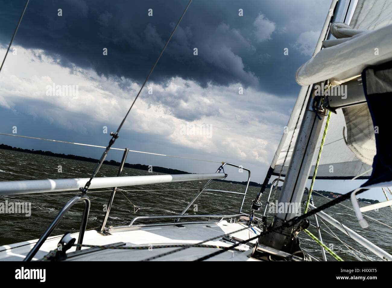 Sailboat in open sea on a storm Stock Photo - Alamy