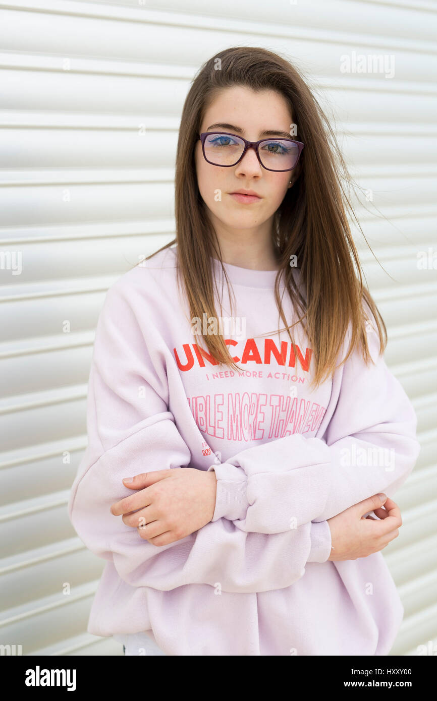 Portrait of a young 15 year old teenager with glasses on a metallic ...