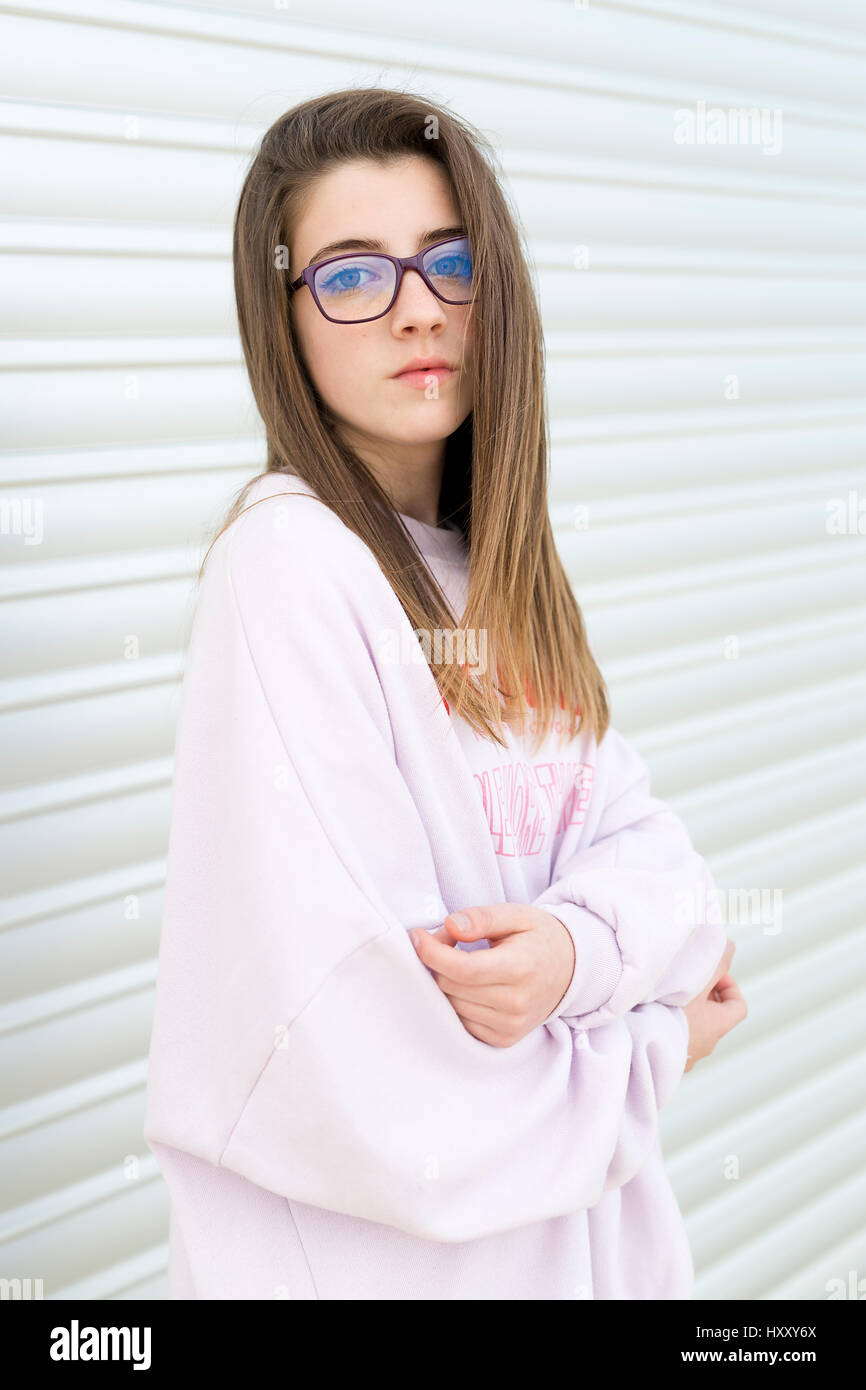Portrait of a young 15 year old teenager with glasses on a metallic ...