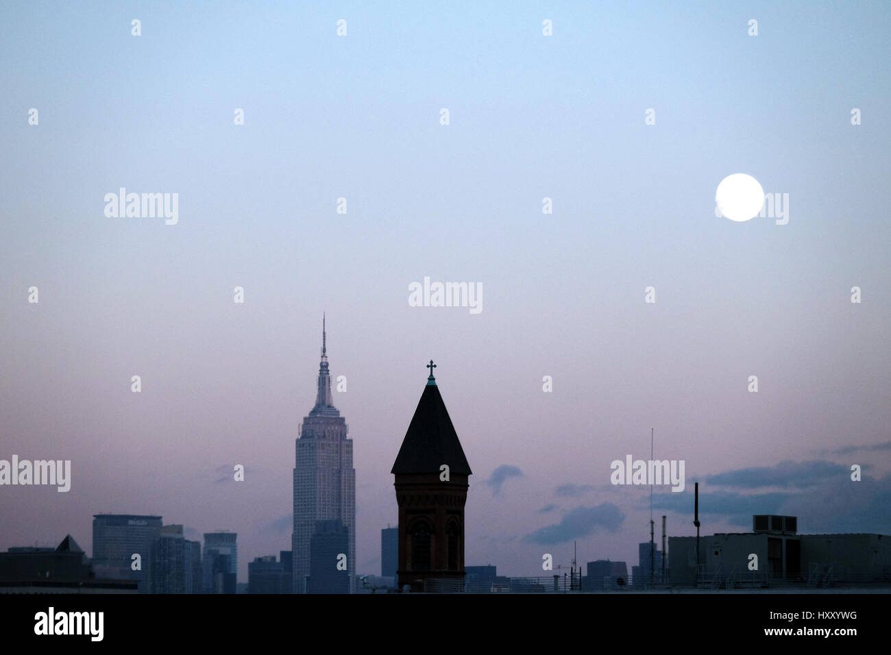 A full moon over New York City and the Empire State Building and a ...