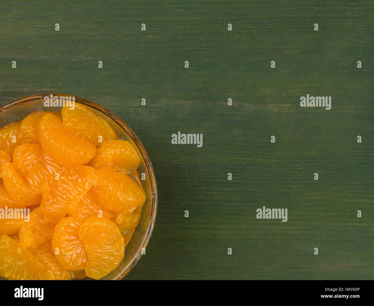 Mandarin Orange Segments in a Bowl Against a Green Background Stock ...