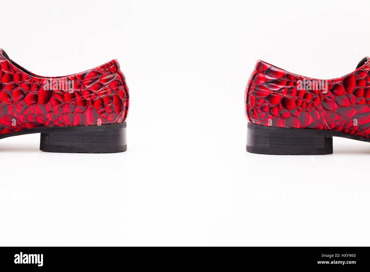 Detail of men's red shoes on white background Stock Photo - Alamy