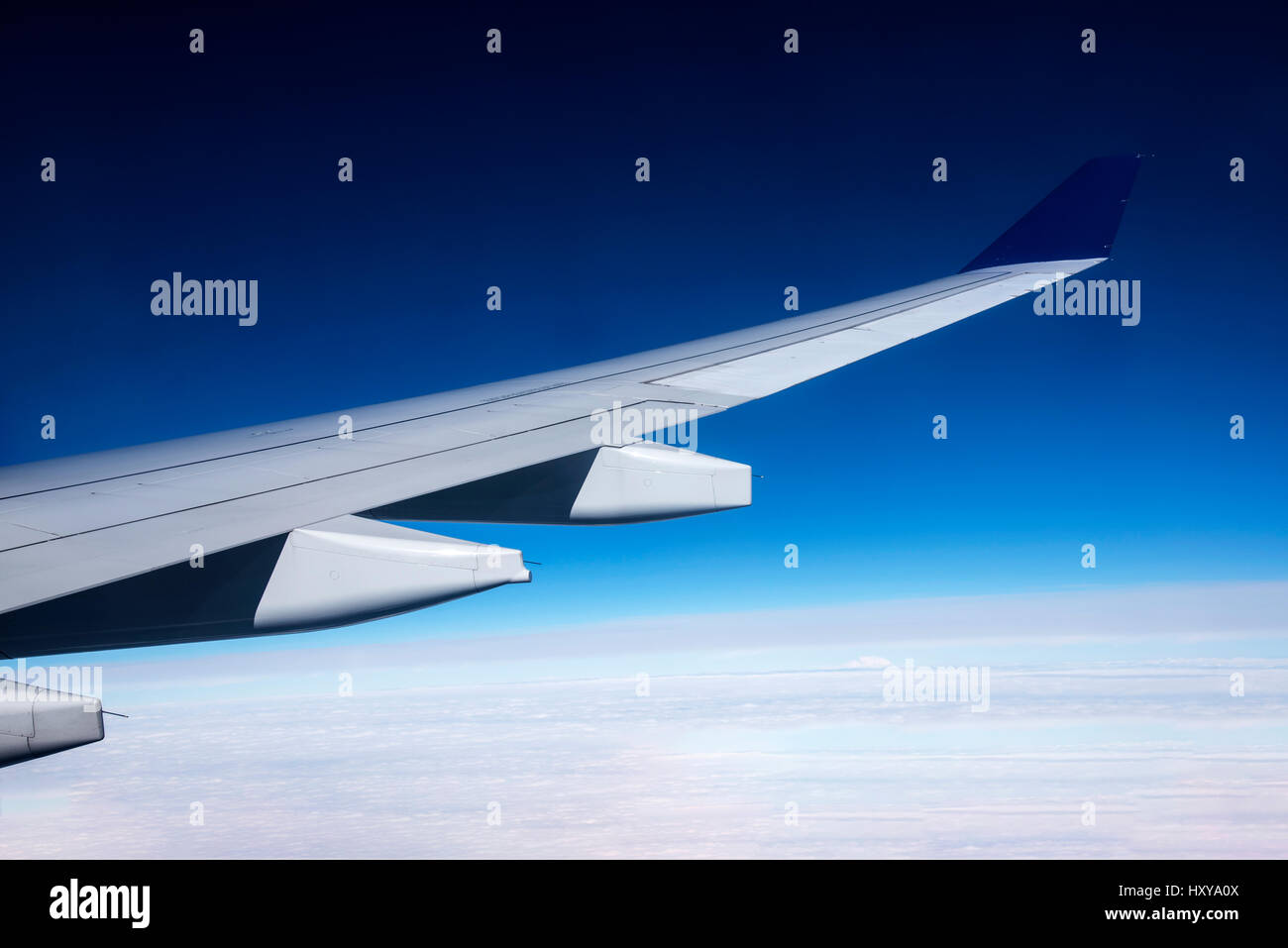 Wing of a flying passenger aircraft Stock Photo - Alamy
