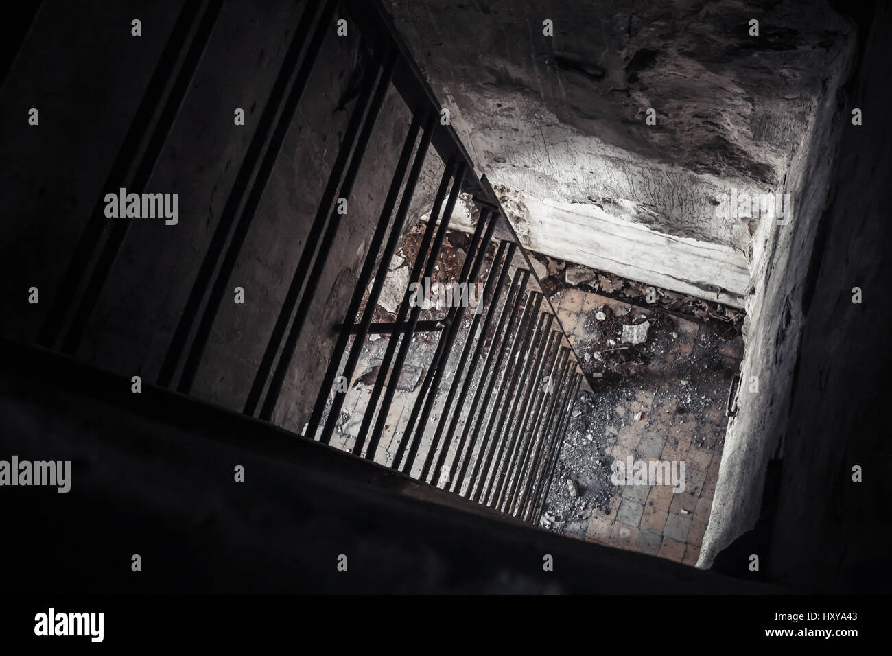 Old empty abandoned bunker interior with rusted metal ladder going down ...