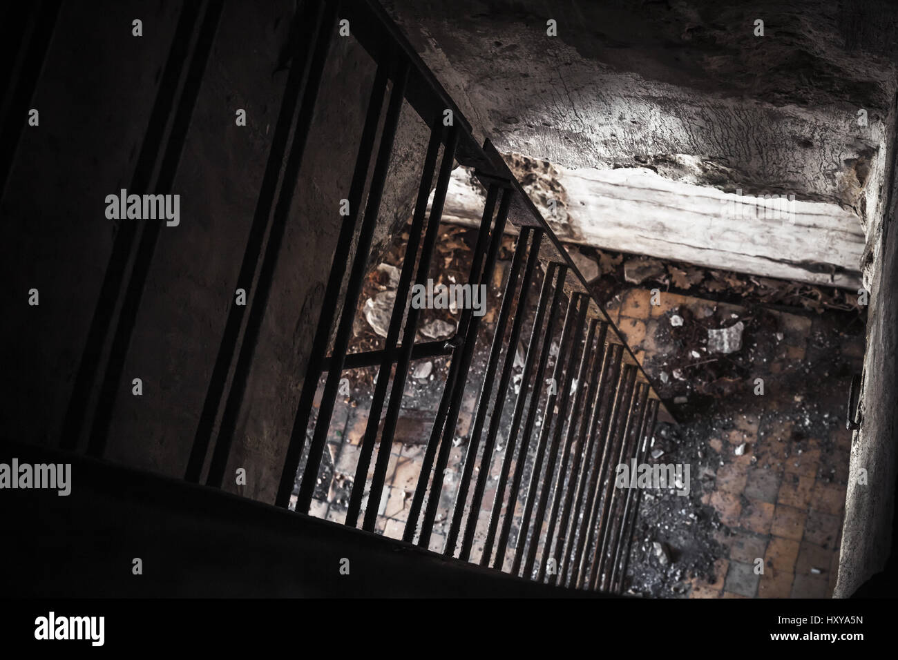 Old empty abandoned bunker interior with rusted metal ladder going down ...