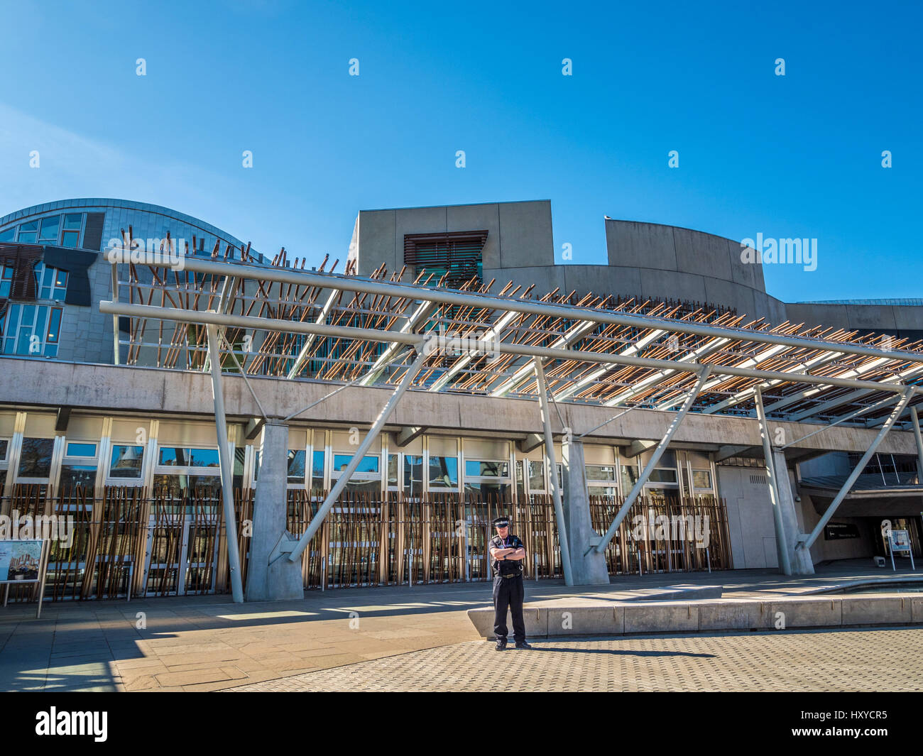Single policeman guarding the front of the Scottish Parliament building ...
