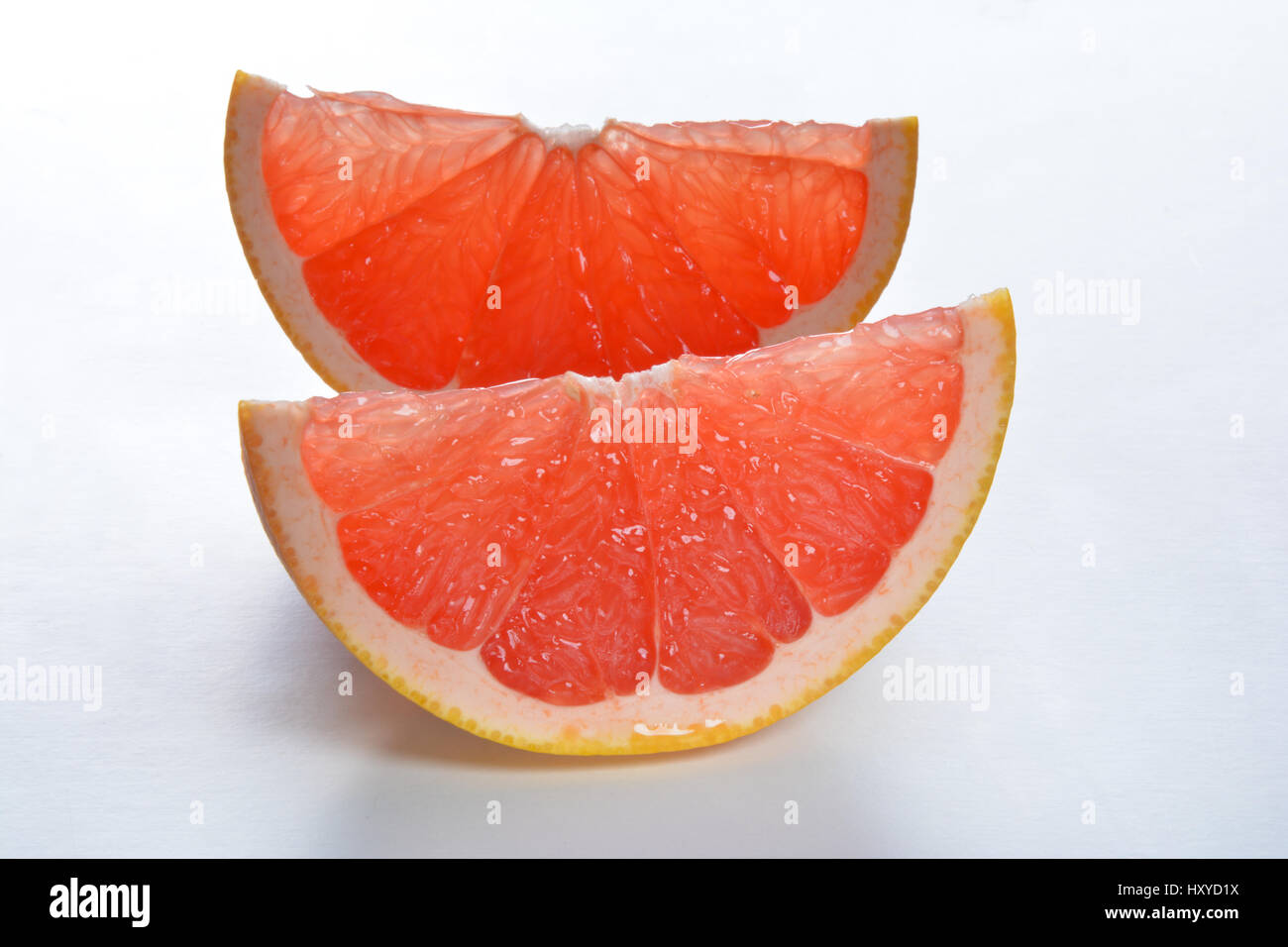 Closeup of two slices of pink grapefruit on a white background Stock ...