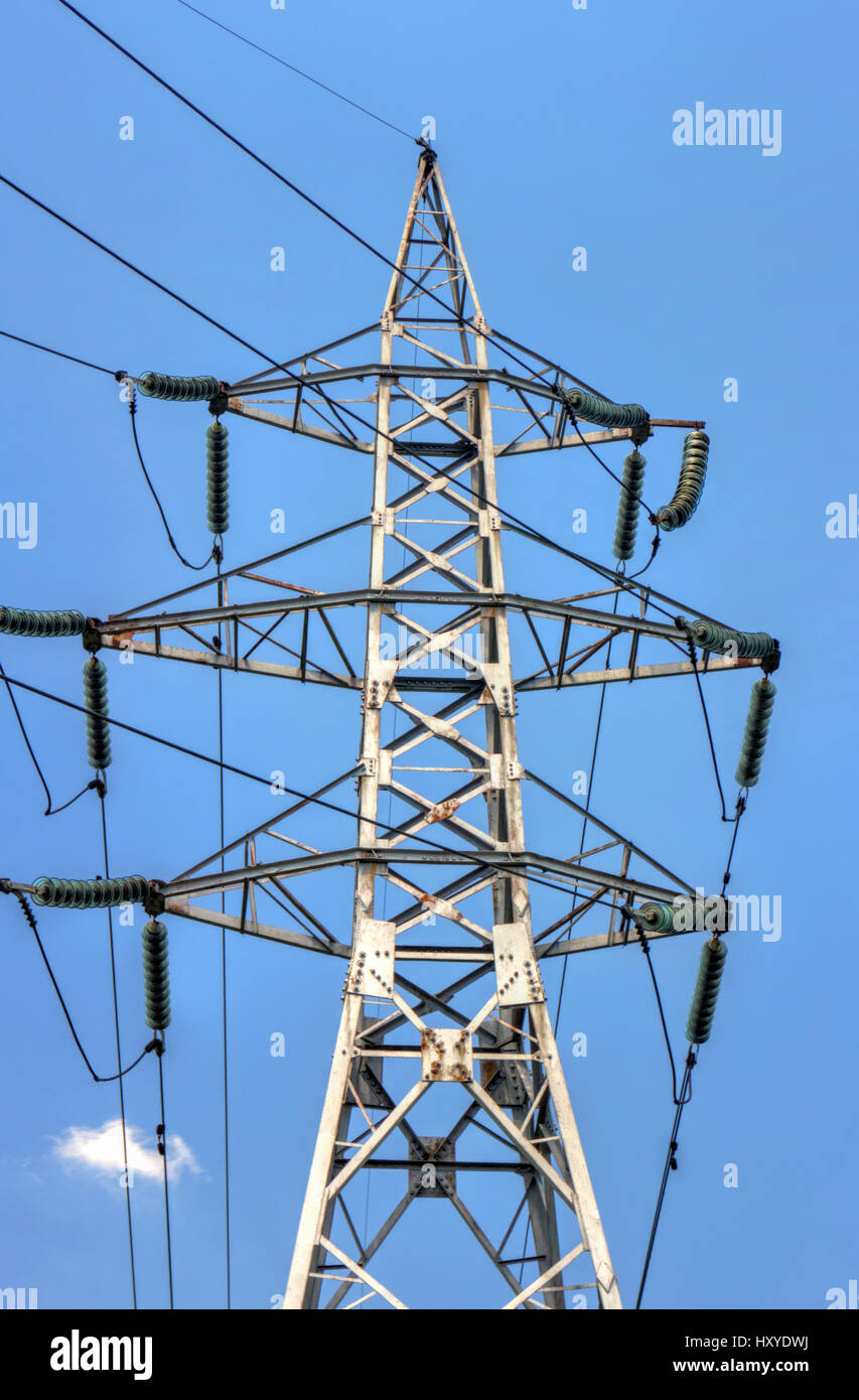 High voltage electrical overhead lines on blue sky Stock Photo - Alamy