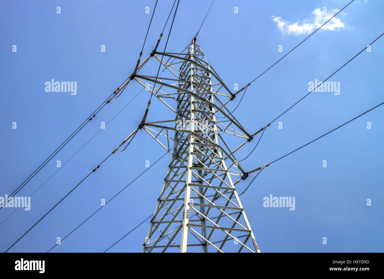 High voltage electrical overhead lines on blue sky Stock Photo - Alamy