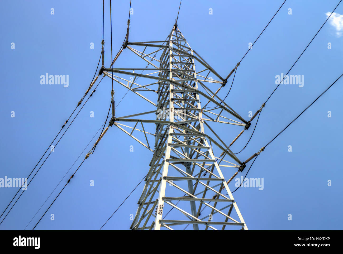 High voltage electrical overhead lines on blue sky Stock Photo - Alamy