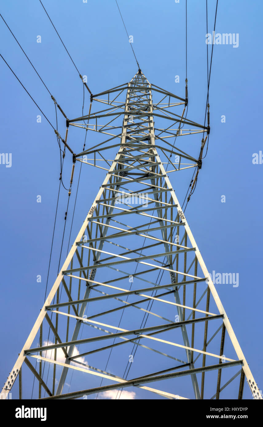 High voltage electrical overhead lines on blue sky Stock Photo - Alamy