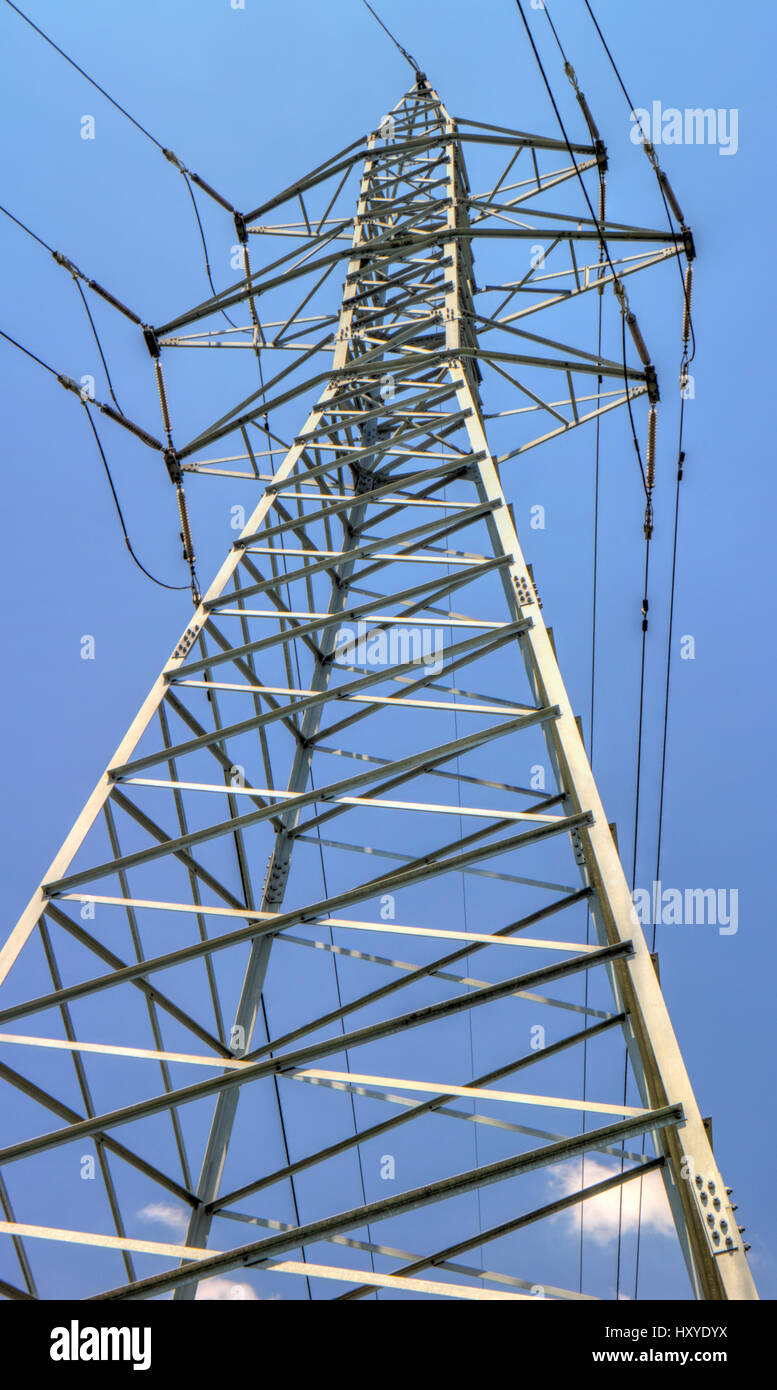 High voltage electrical overhead lines on blue sky Stock Photo - Alamy