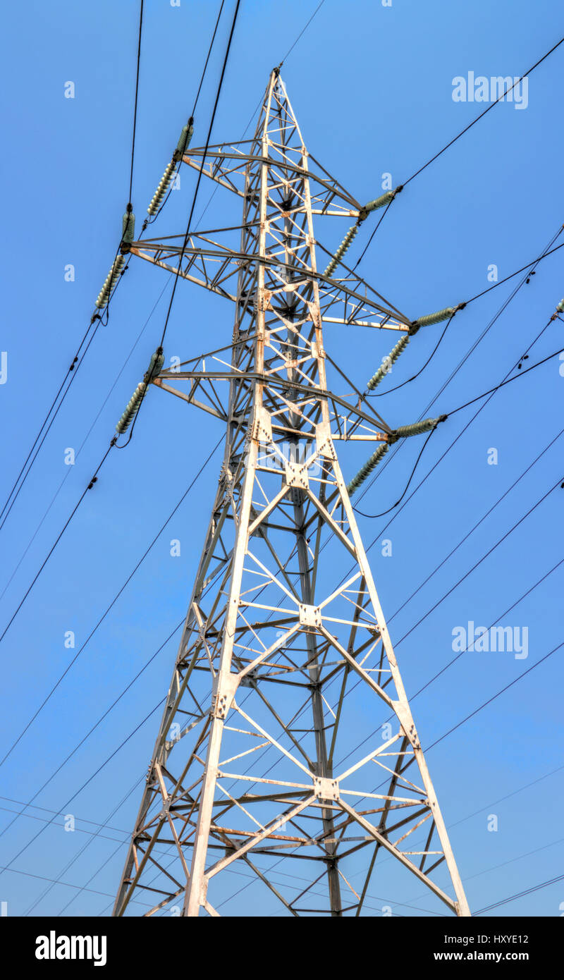 High voltage electrical overhead lines on blue sky Stock Photo - Alamy