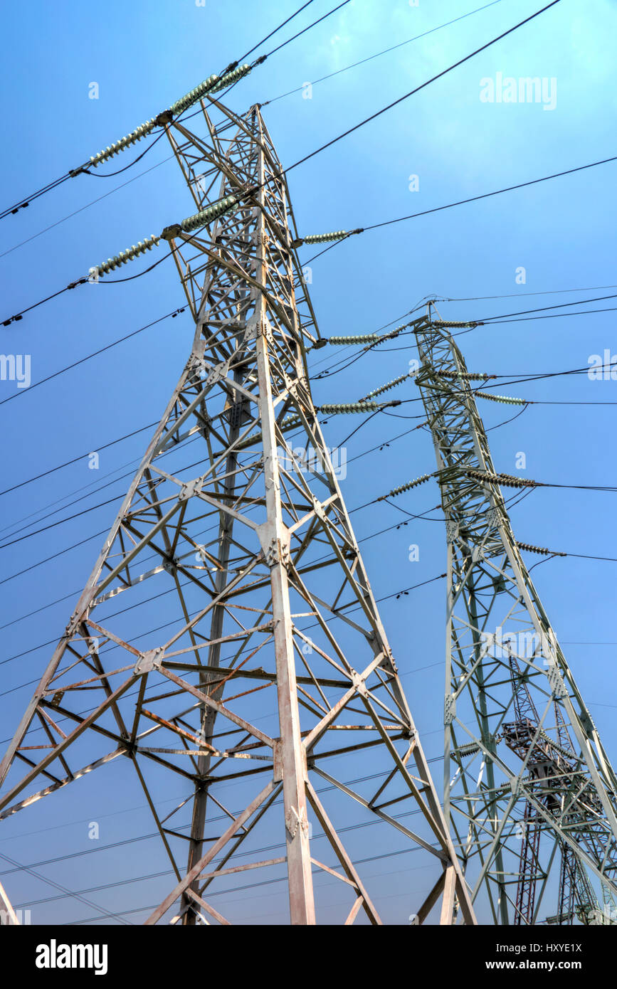 High voltage electrical overhead lines on blue sky Stock Photo - Alamy
