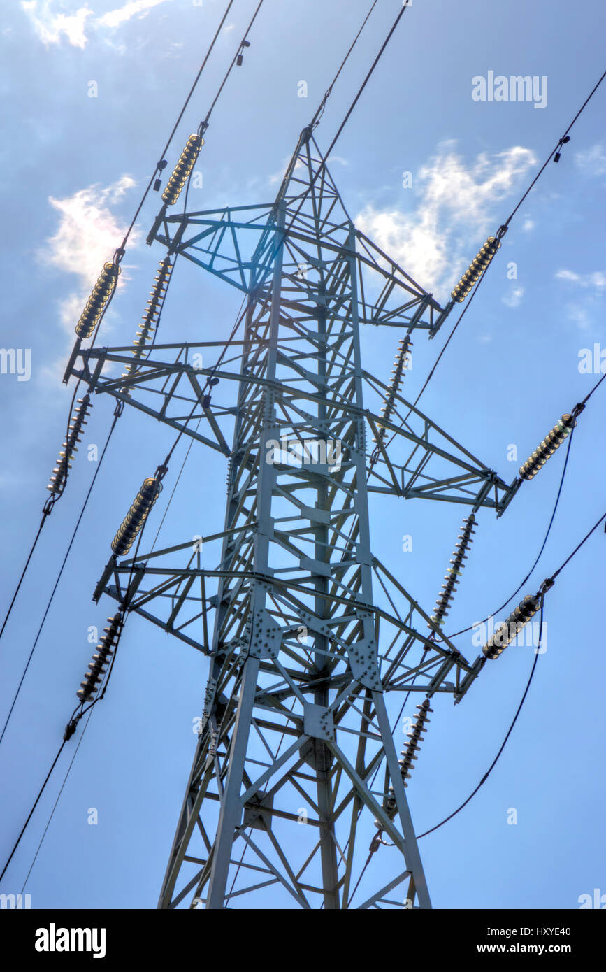 High voltage electrical overhead lines on blue sky Stock Photo - Alamy