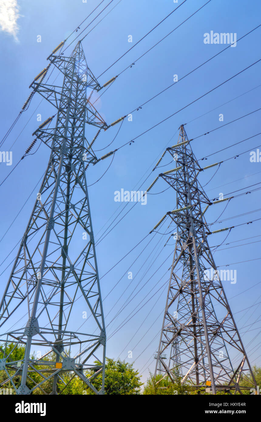 High voltage electrical overhead lines on blue sky Stock Photo - Alamy
