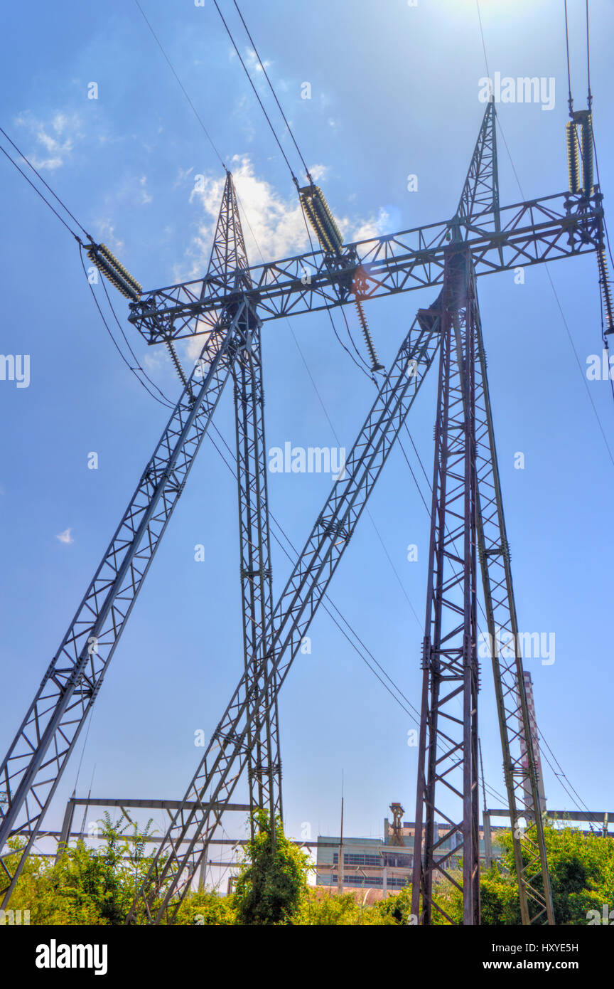 High voltage electrical overhead lines on blue sky Stock Photo - Alamy