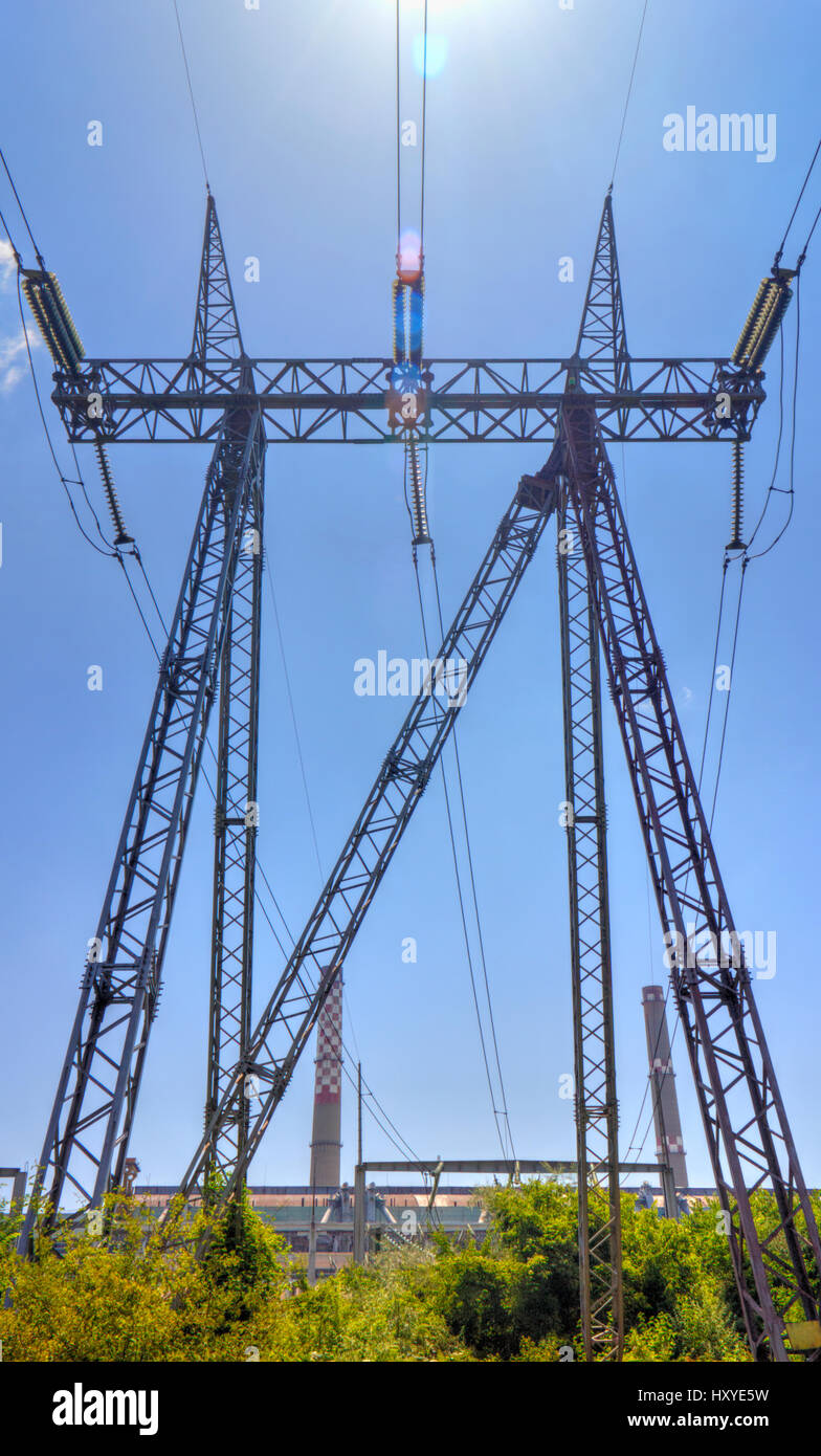 High voltage electrical overhead lines on blue sky Stock Photo - Alamy