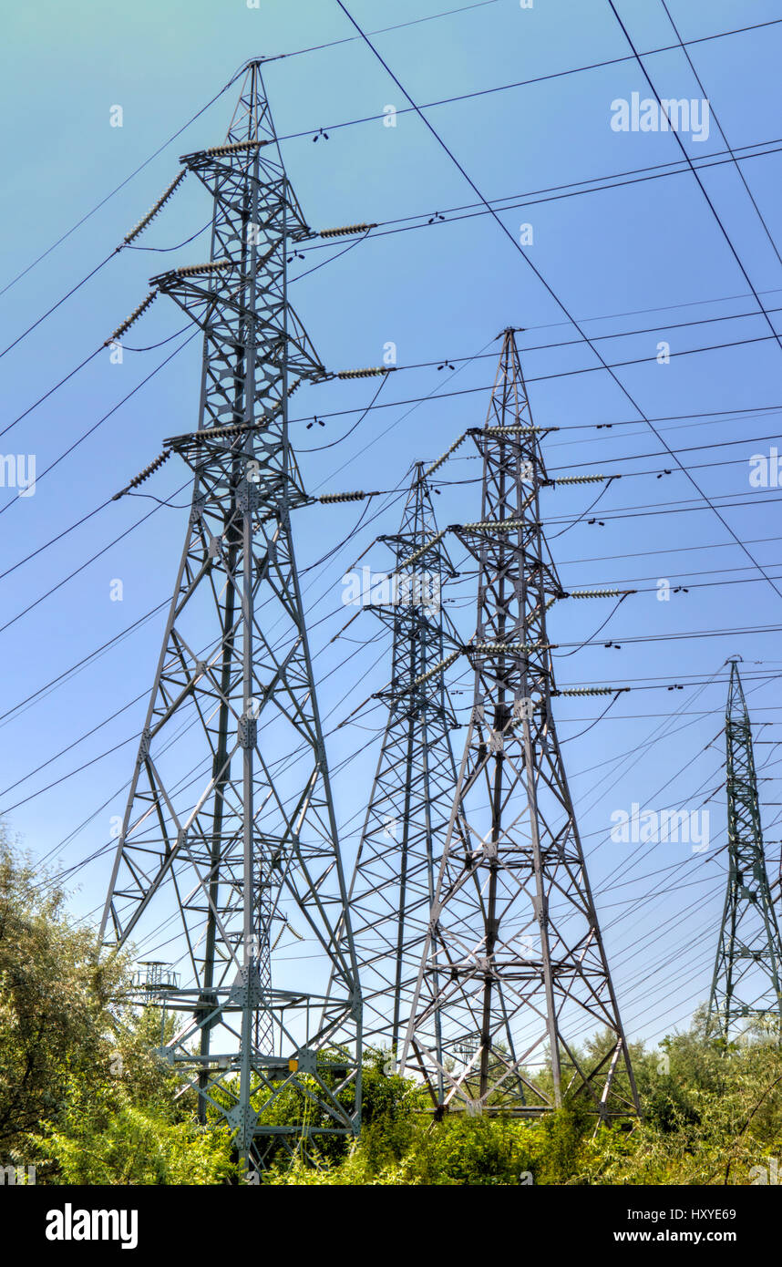 High voltage electrical overhead lines on blue sky Stock Photo - Alamy