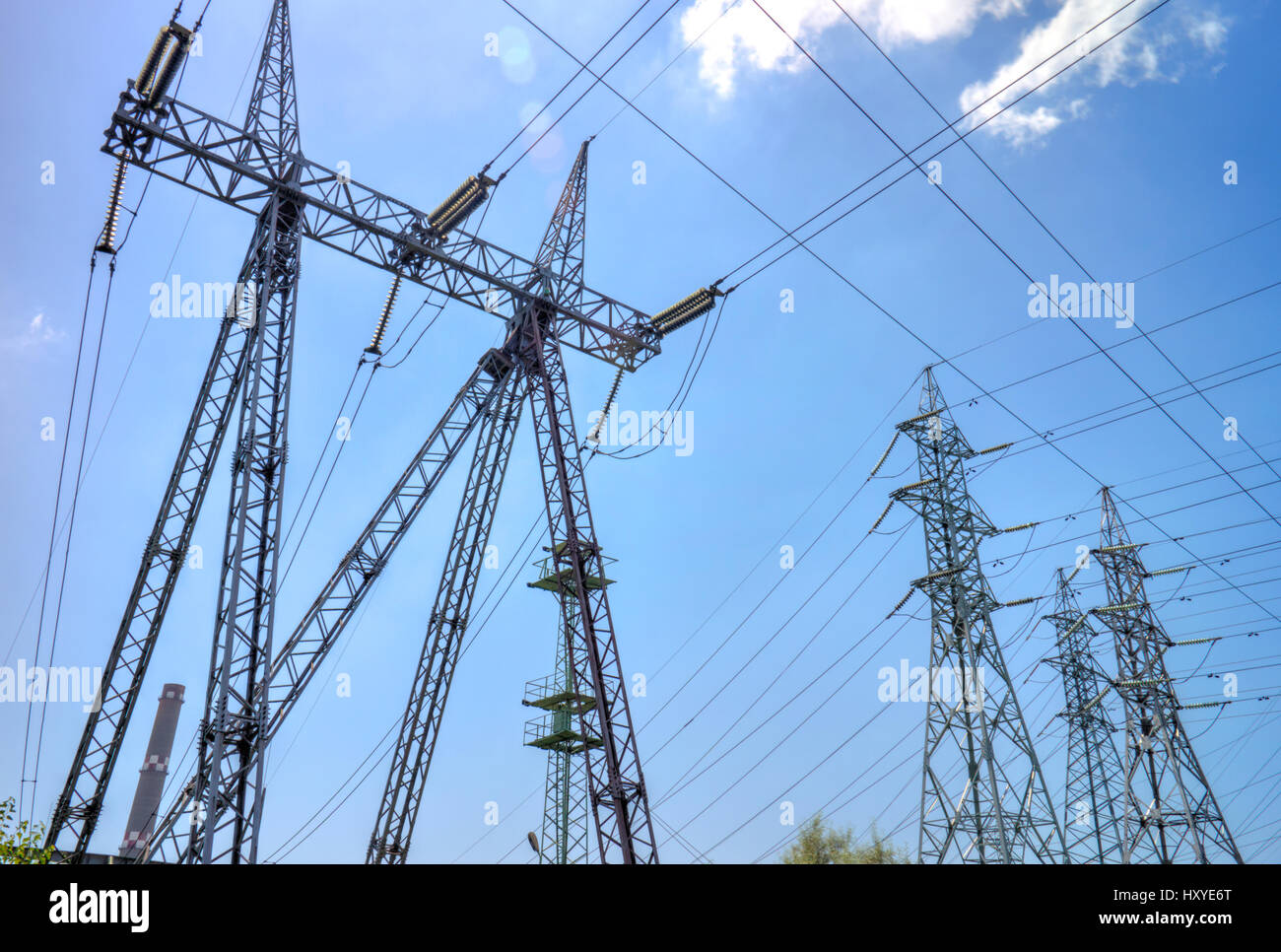 High voltage electrical overhead lines on blue sky Stock Photo - Alamy